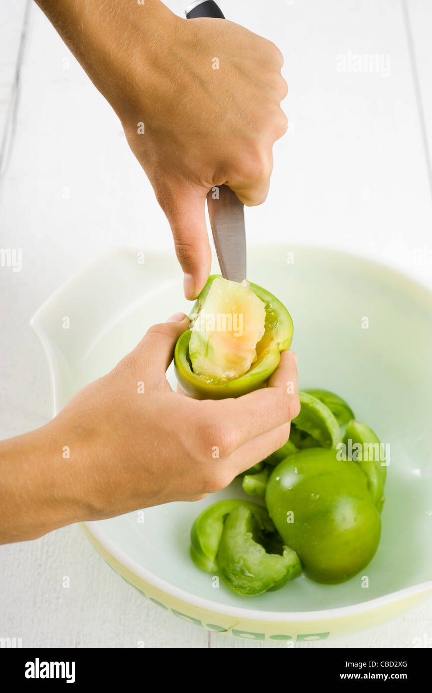 Removing pulp from green tomatoes Stock Photo - Alamy