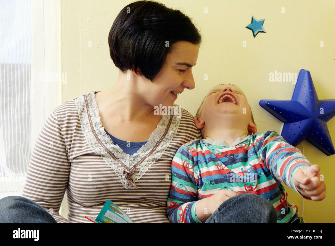 Mum laughing with young son Stock Photo - Alamy