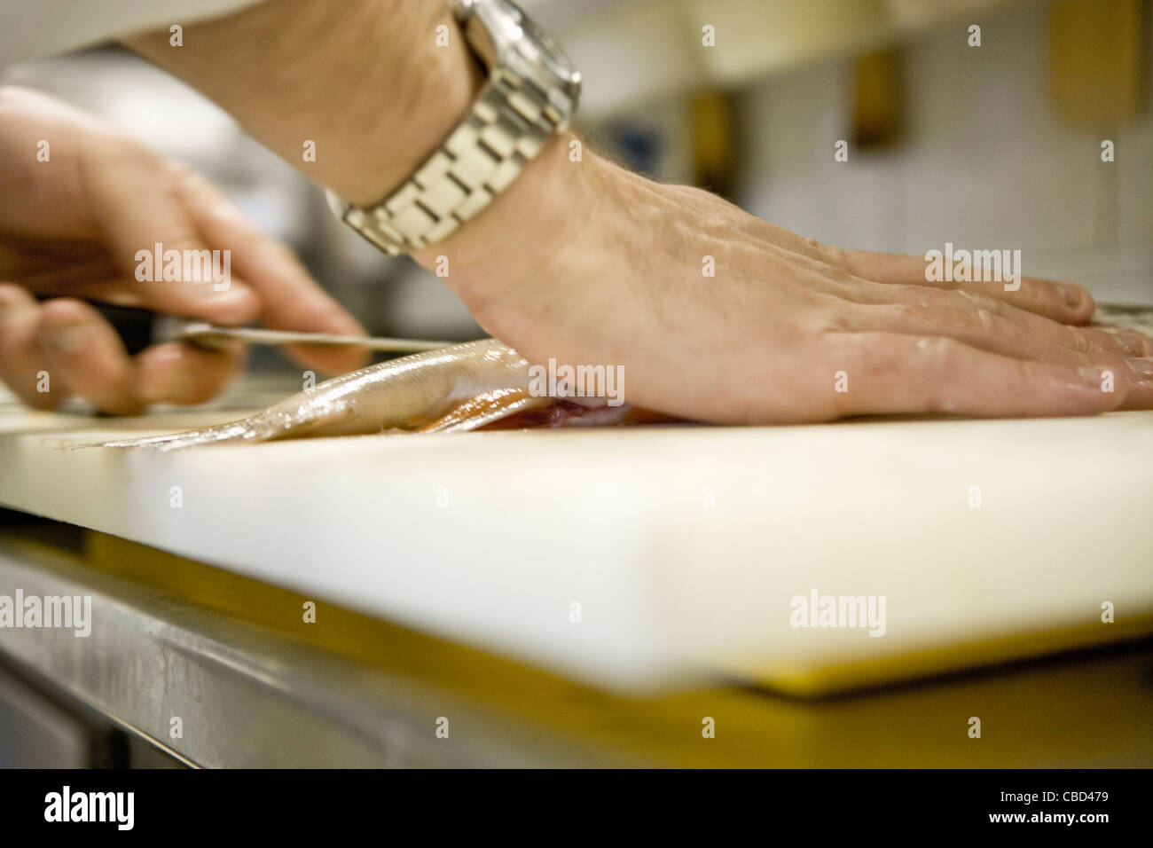 Man cleaning fish, cropped Stock Photo - Alamy