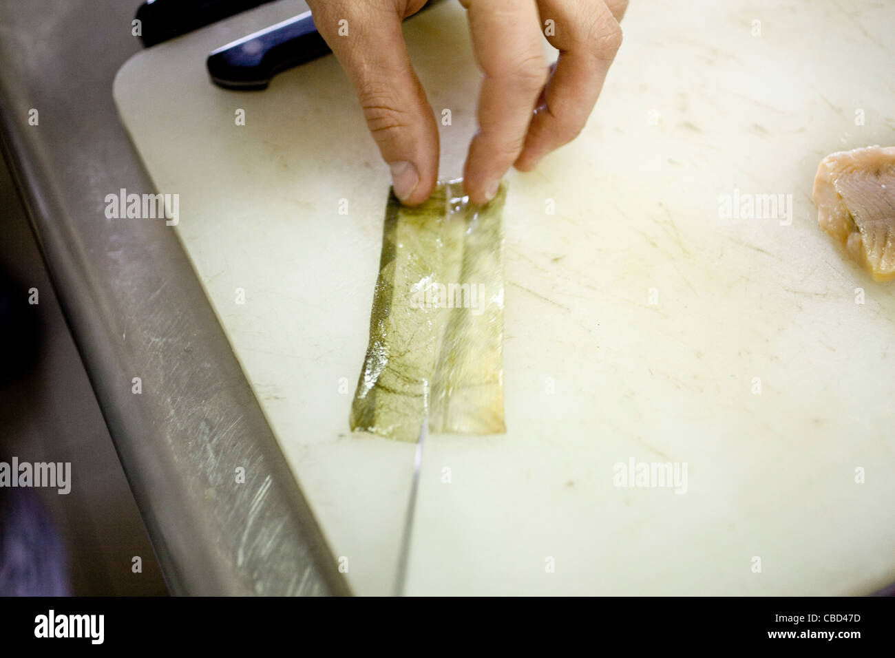 Removing skin from fish hi-res stock photography and images - Alamy