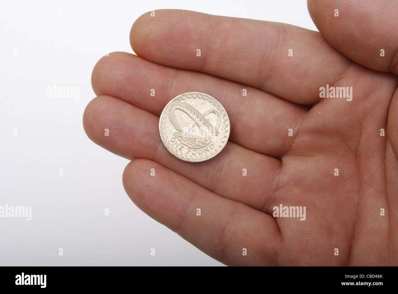 One pound coin on hand Stock Photo - Alamy