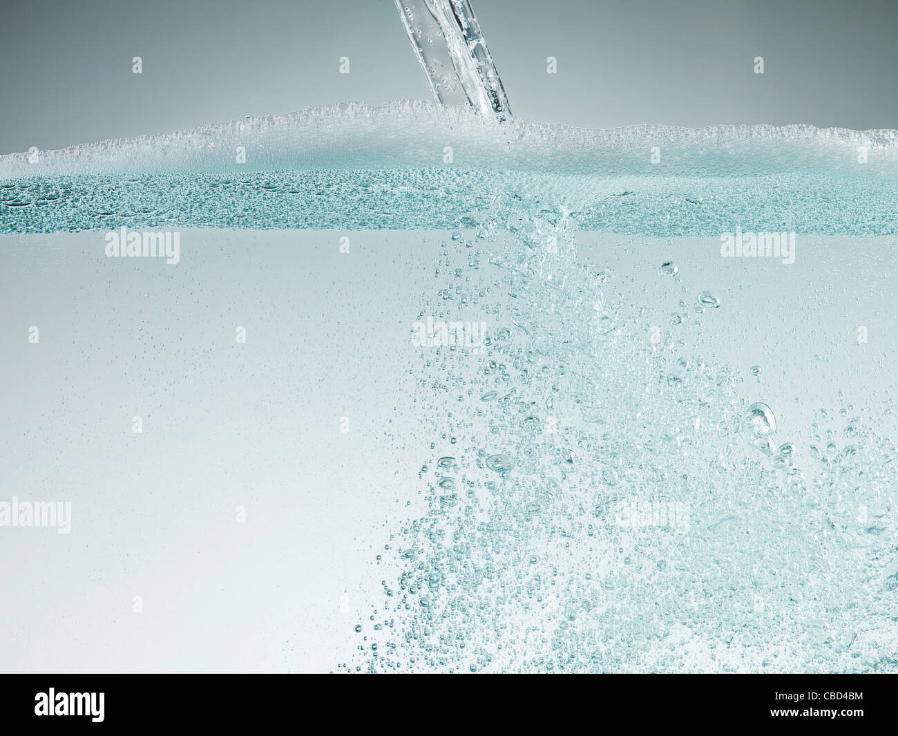 Stream pouring into soapy water Stock Photo - Alamy
