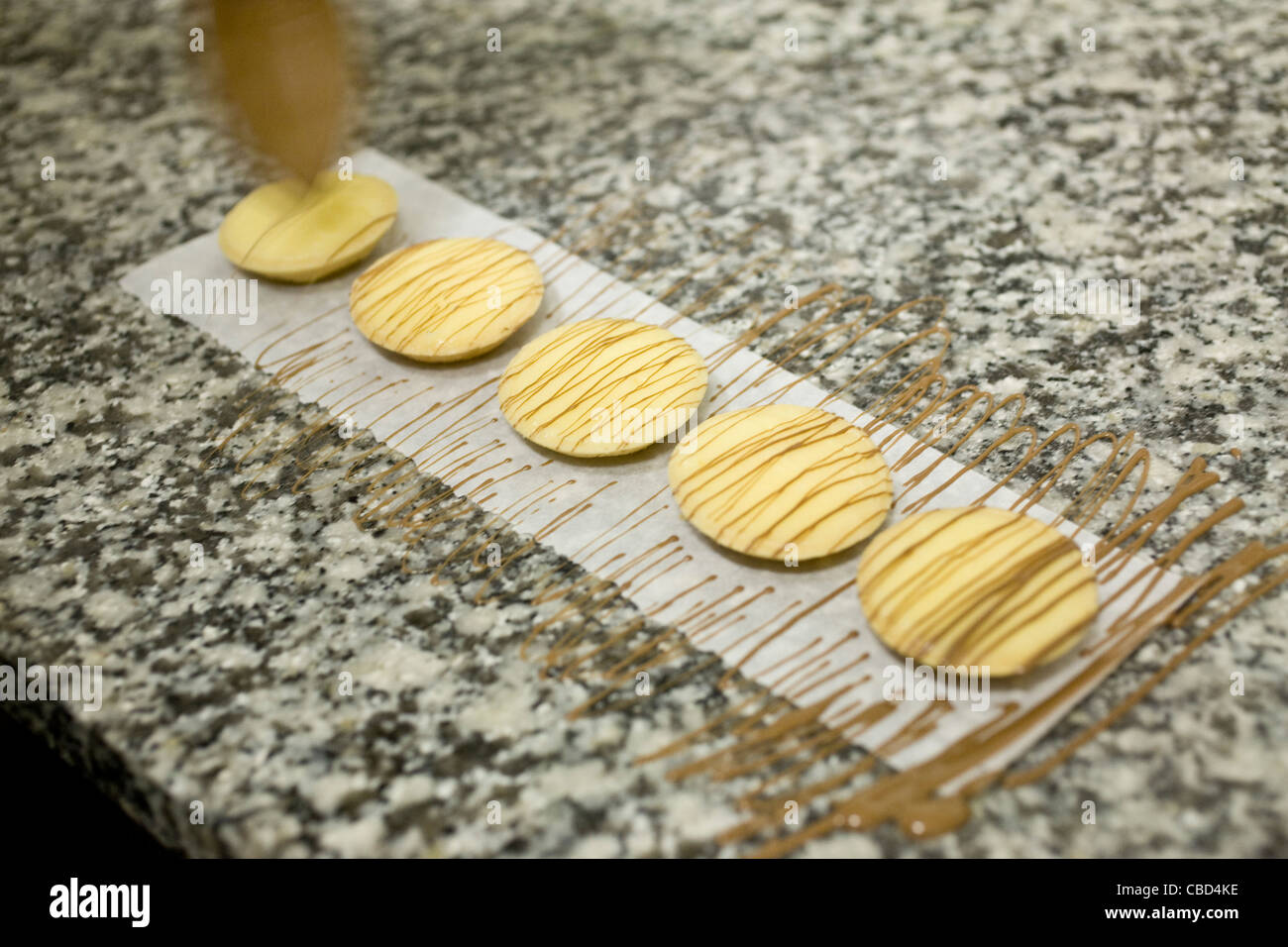 Decorating pastries, cropped Stock Photo - Alamy