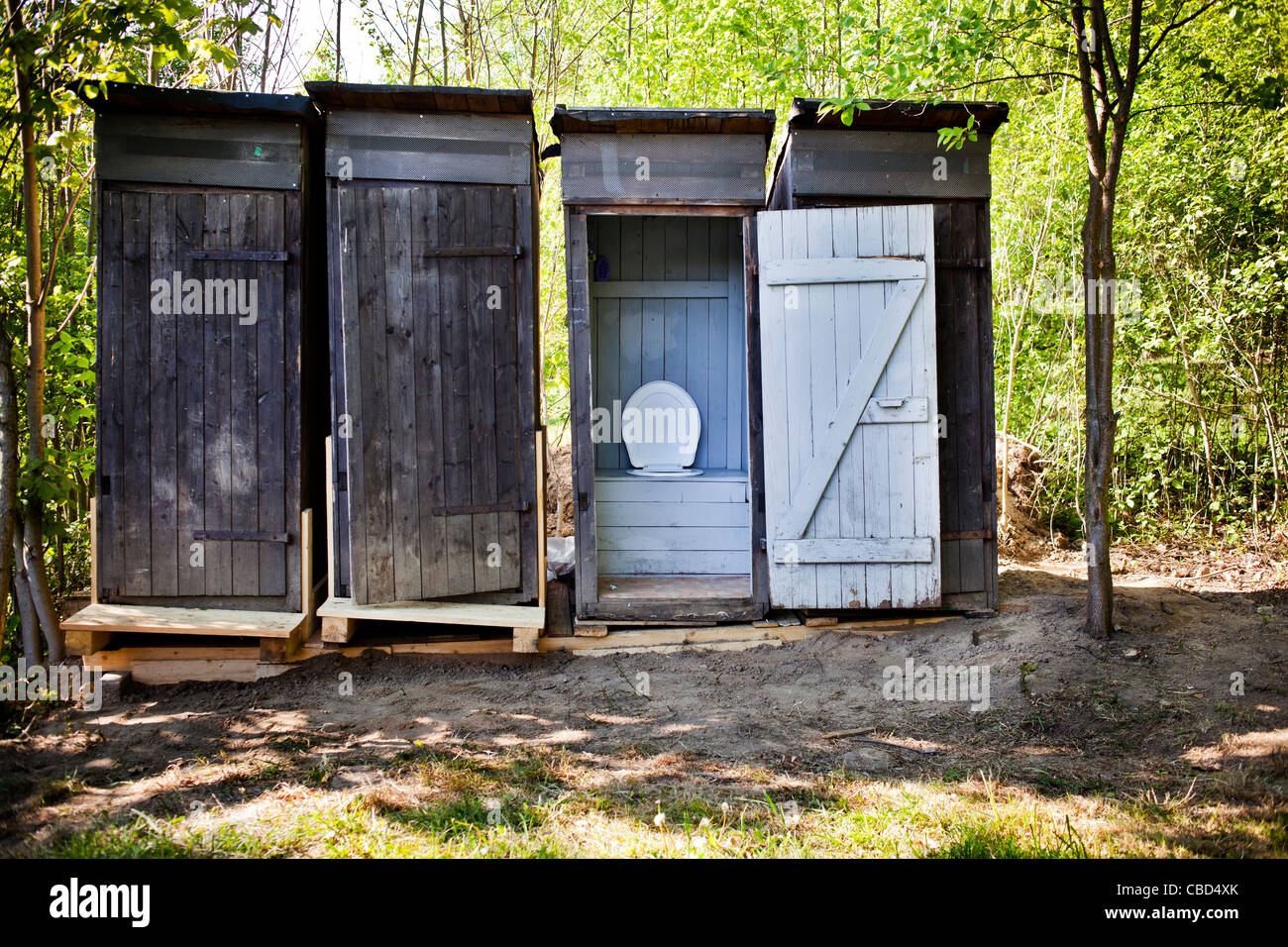 A row of primitive outdoor toilets without running water, latrine, WC ...