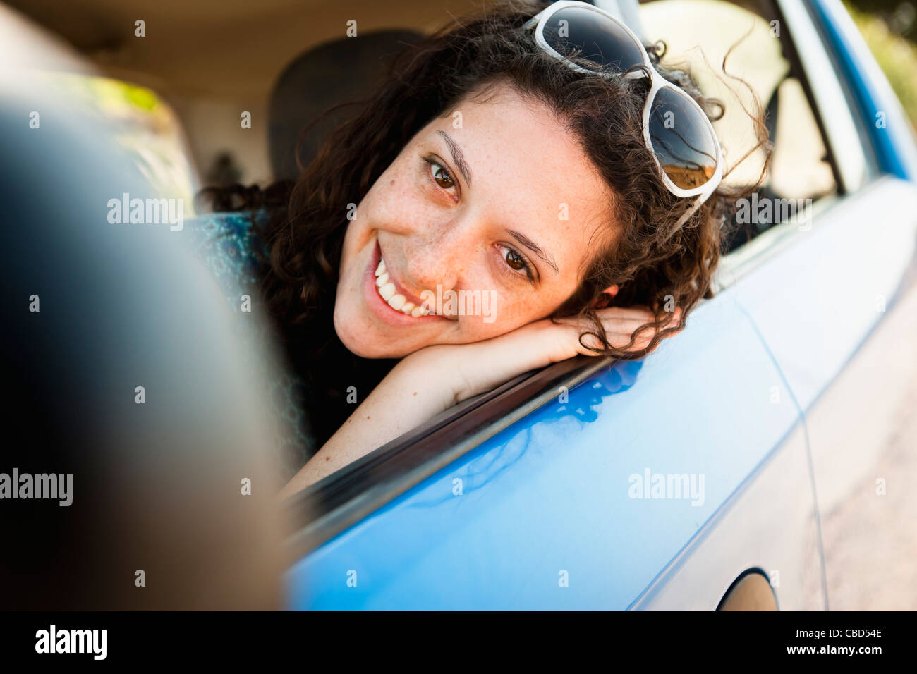Woman smiling in car Stock Photo - Alamy