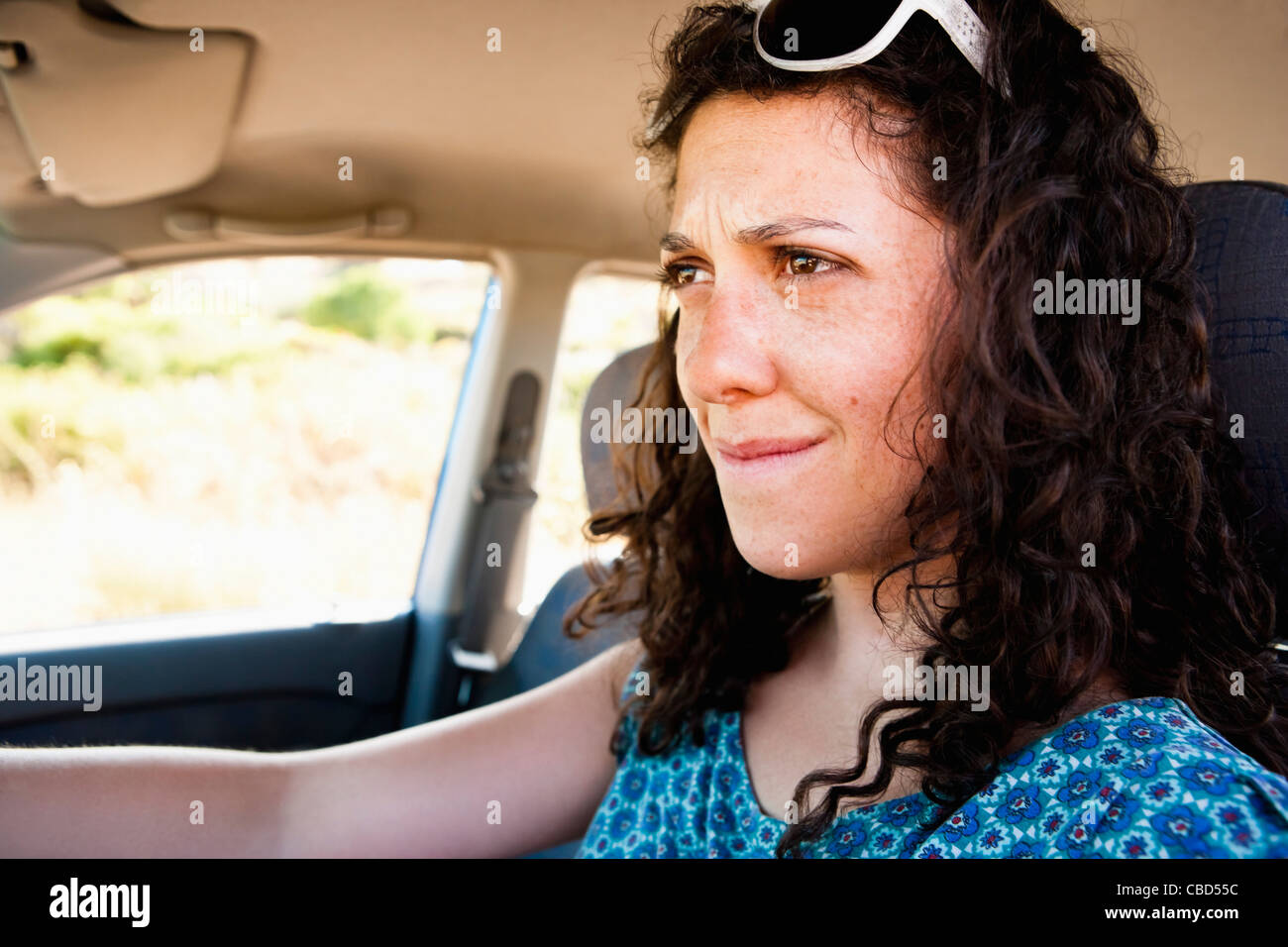Frustrated woman driving car Stock Photo - Alamy