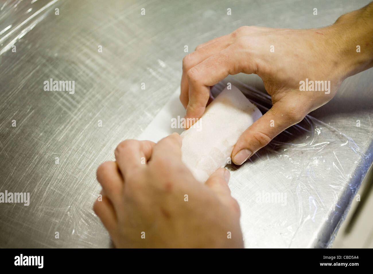 Chef wrapping ingredients in paper Stock Photo - Alamy