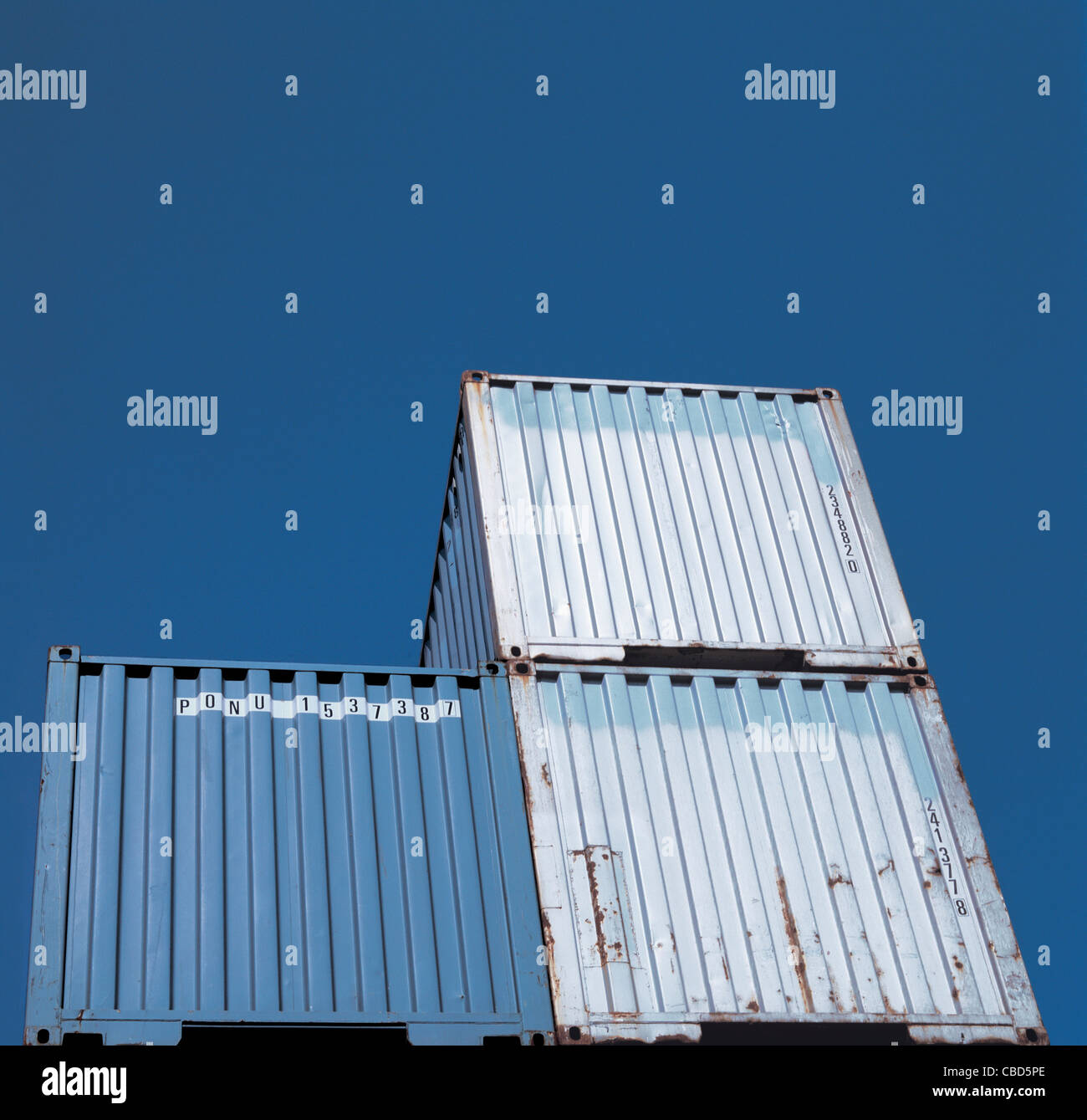 Shipping containers against blue sky Stock Photo - Alamy