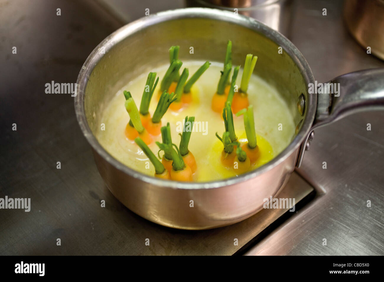 Carrots cooking in pan Stock Photo - Alamy
