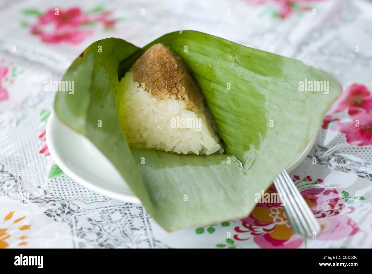 Pulut inti, pyramid shaped glutinous rice wrapped in banana leaf Stock ...