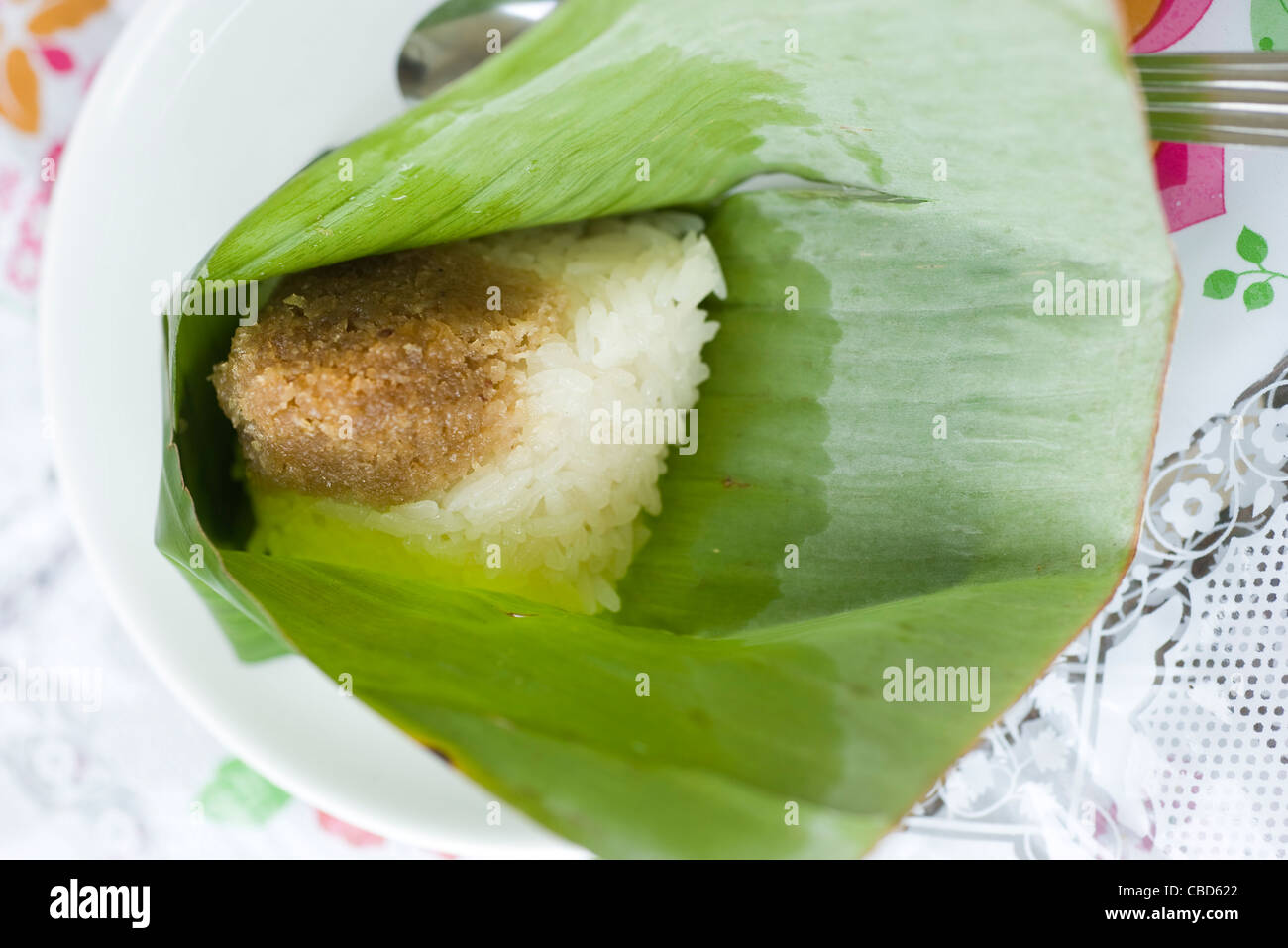 Pulut inti, pyramid shaped glutinous rice wrapped in banana leaf Stock ...