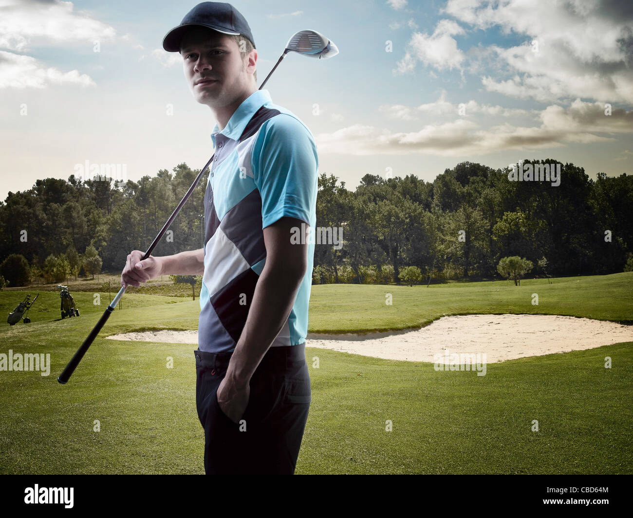 Man carrying golf club on course Stock Photo - Alamy