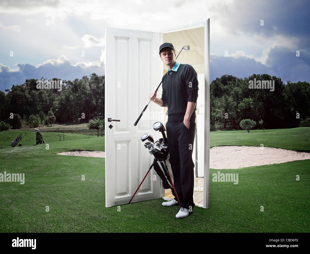 Man emerging from door on golf course Stock Photo - Alamy