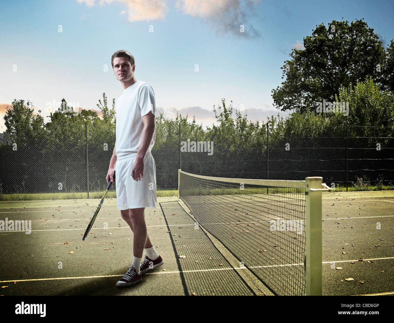 Man standing on tennis court Stock Photo - Alamy