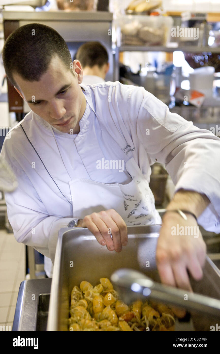 Chef cleaning shrimps under faucet Stock Photo - Alamy