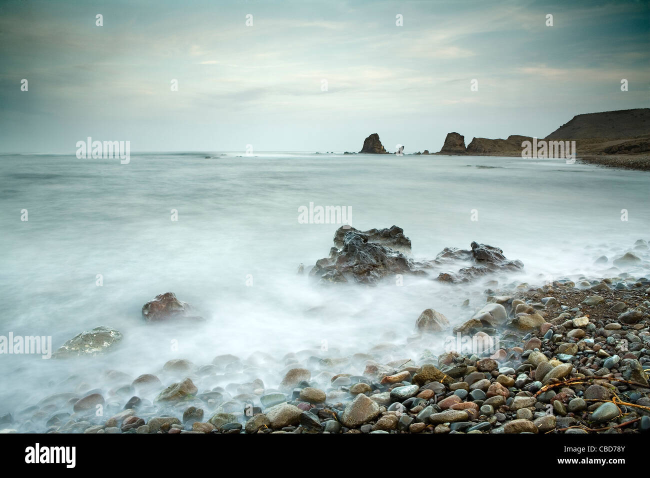 Time lapse view of waves on rocky beach Stock Photo - Alamy