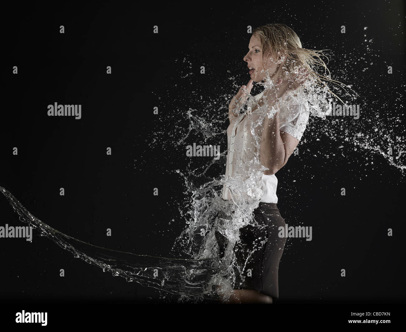 Young woman being splashed with water hi-res stock photography and ...