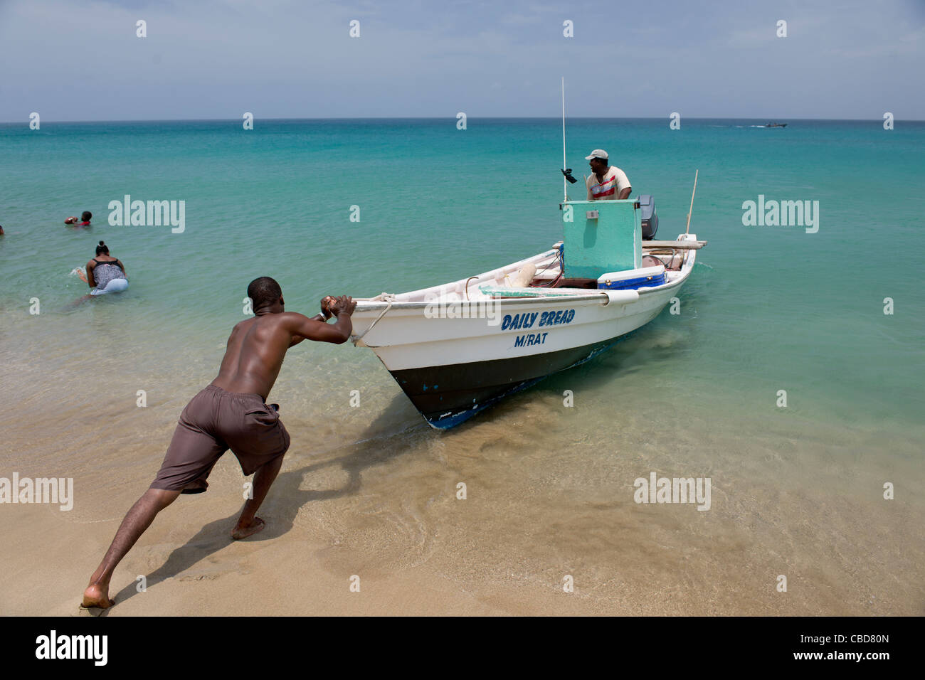 Fishing Boat being pushed out into the waters of Rendezvous Bay ...