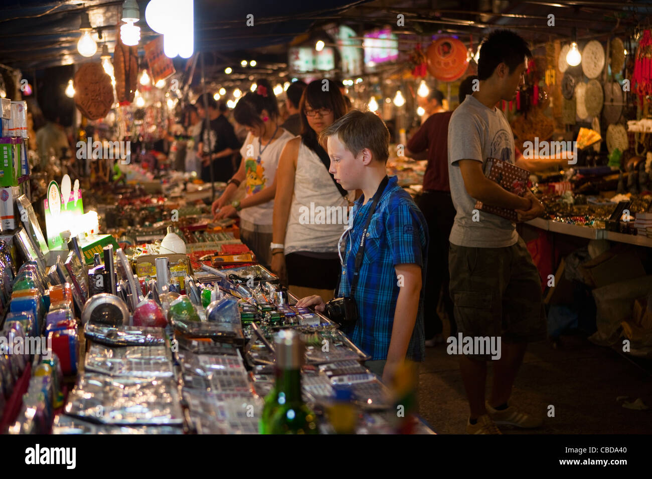 Young Boy shopping at Temple Street Night Market Stock Photo - Alamy
