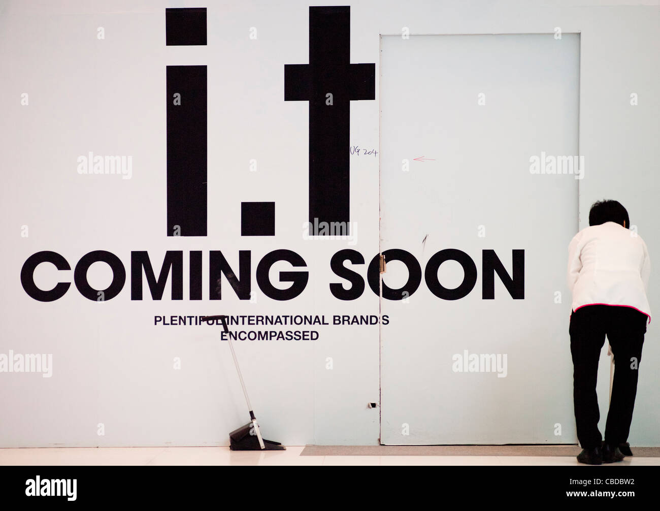 A shop front of a shop about to open in a shopping mall in Hong Kong ...