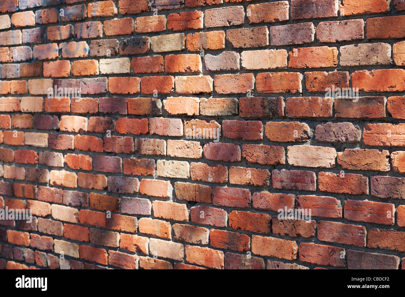 Red brick wall with mottled light Stock Photo - Alamy