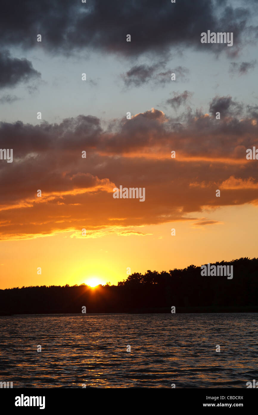 Sunset over a lake Stock Photo - Alamy