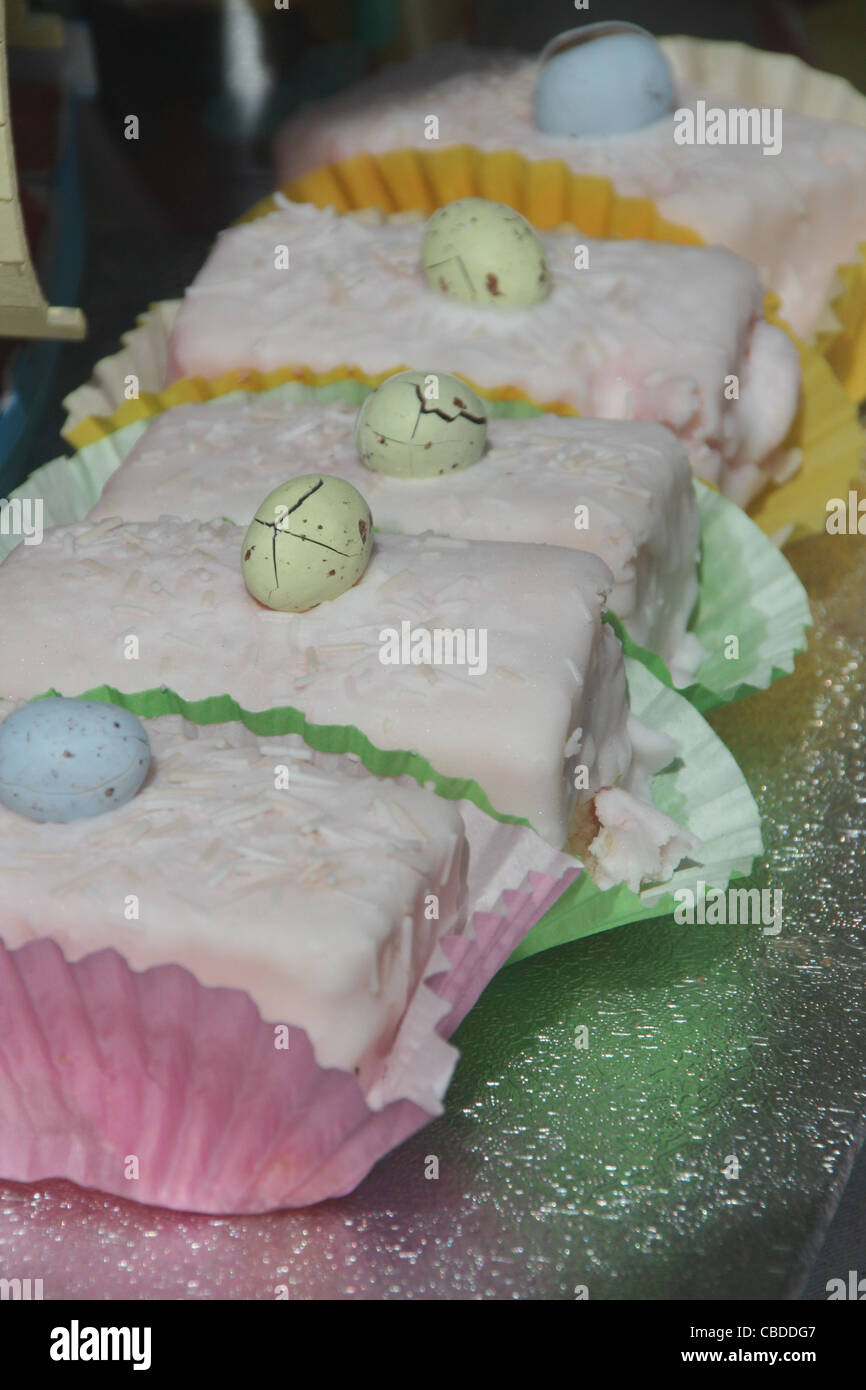 colourful cakes with icing sugar in bakery shop window Stock Photo - Alamy