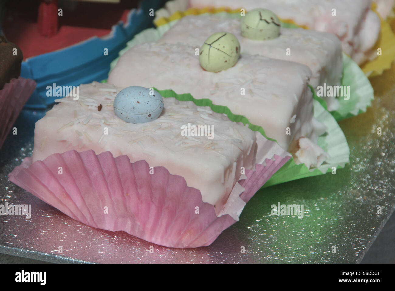 colourful cakes with icing sugar in bakery shop window Stock Photo - Alamy