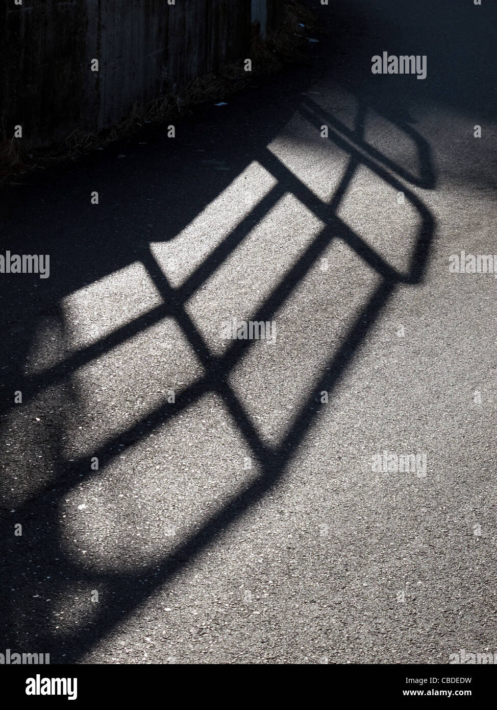 metal steel fence railings shadow on street road in city town Stock ...