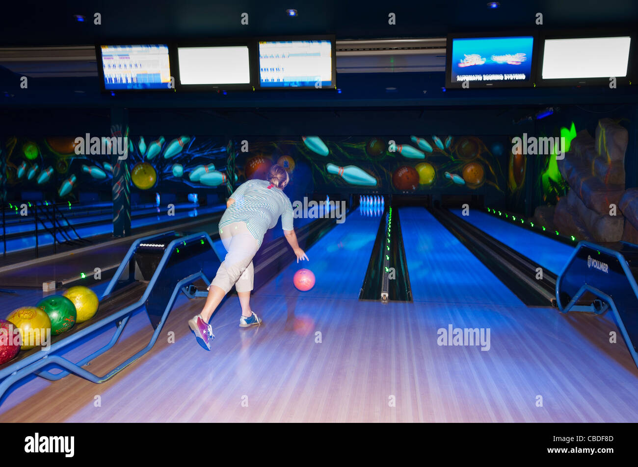 A woman ten pin bowling showing movement at Center Parcs in Elveden ...