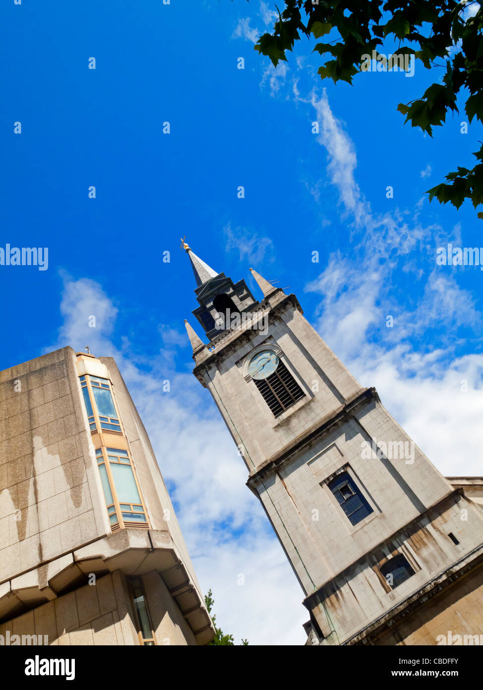 Traditonal church tower next to modern office building in the City of ...