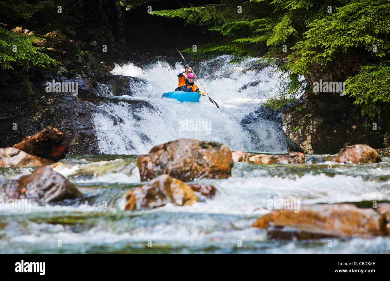 A woman kayaking down a series of small waterfalls, Snoqualmie River ...