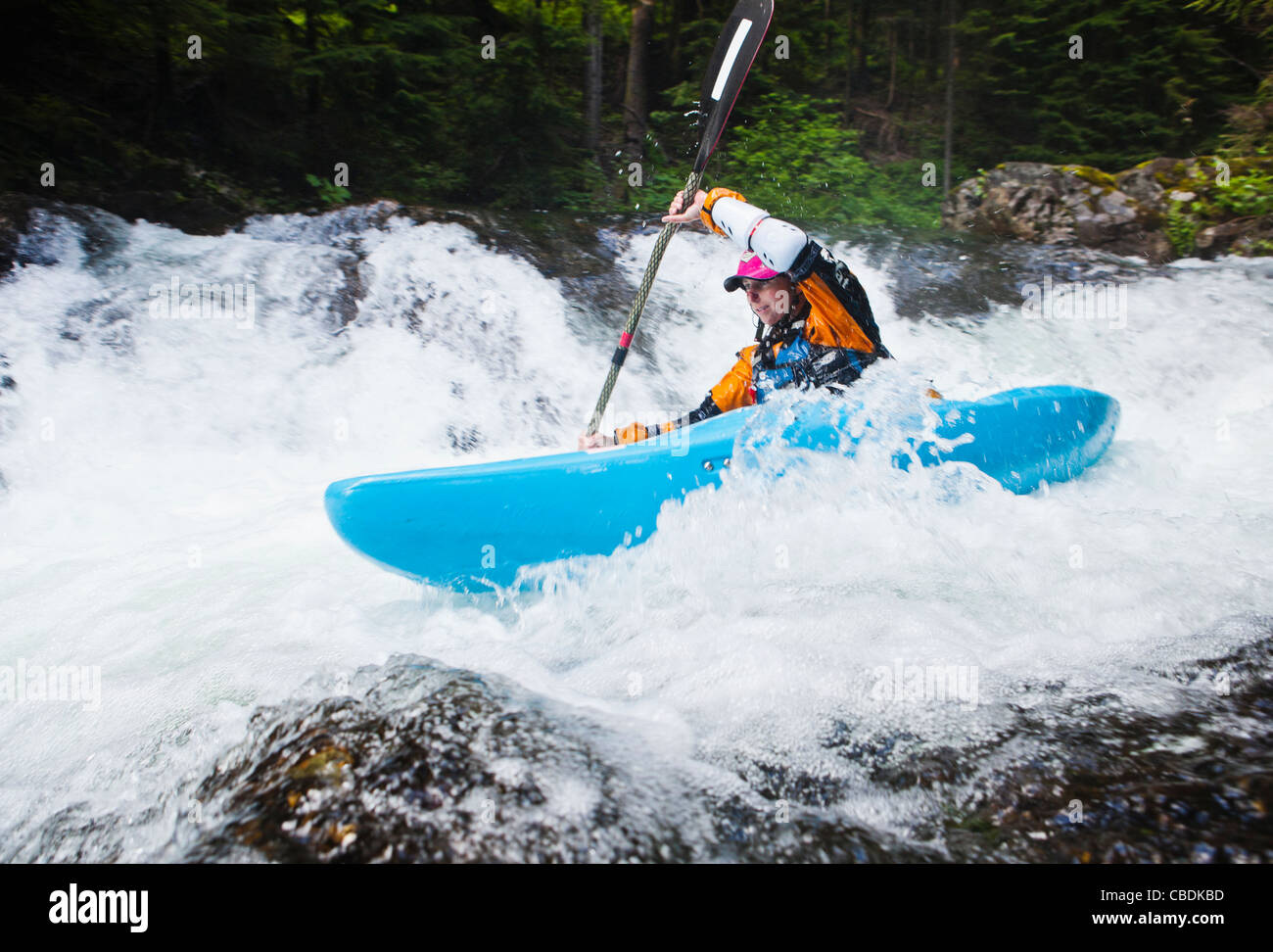 A woman kayaking down a series of small waterfalls, Snoqualmie River ...