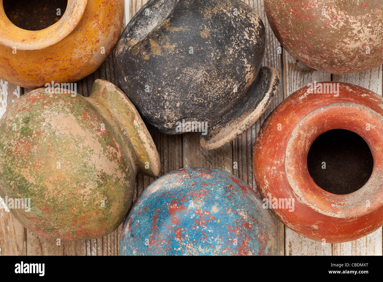 clay pots (planters) with a color grunge finish on wooden surface Stock ...
