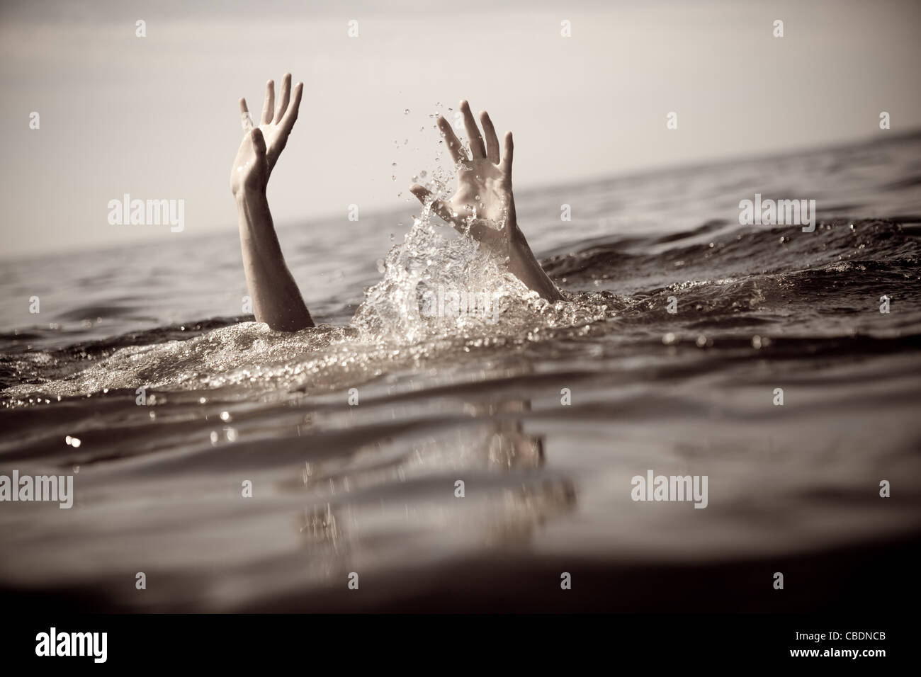 Seeking rescue. Drowning man Stock Photo - Alamy