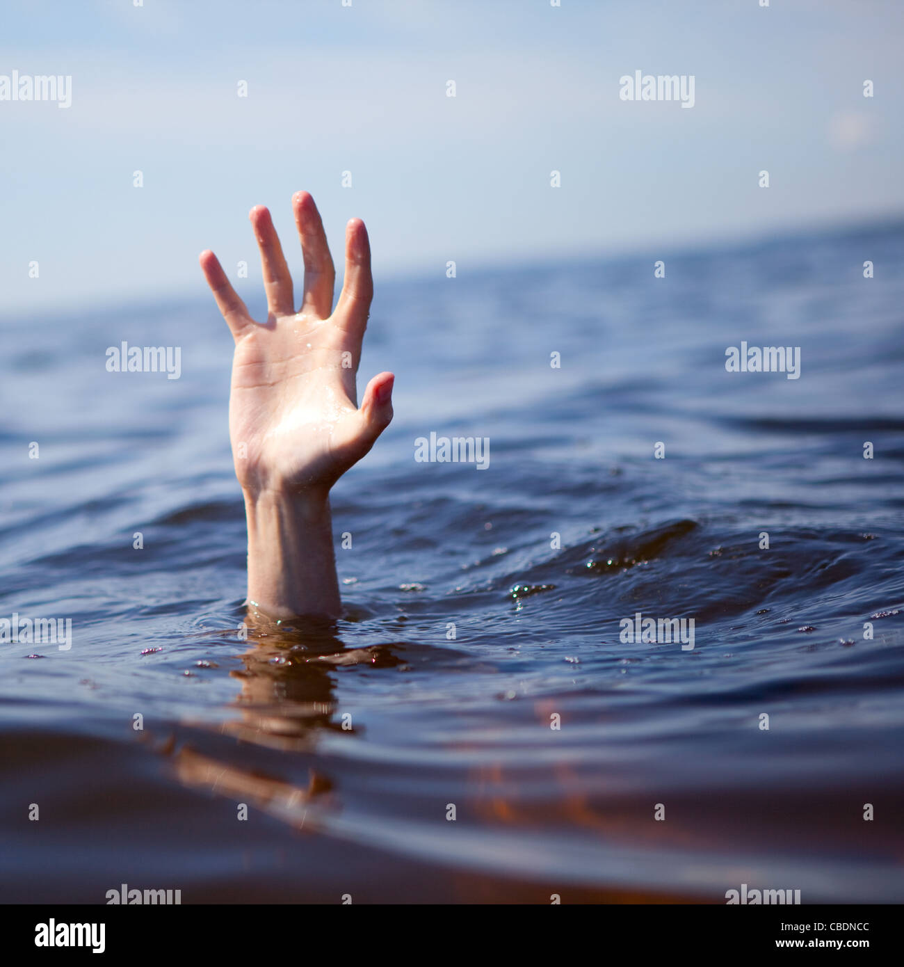 Seeking rescue. Drowning man Stock Photo - Alamy