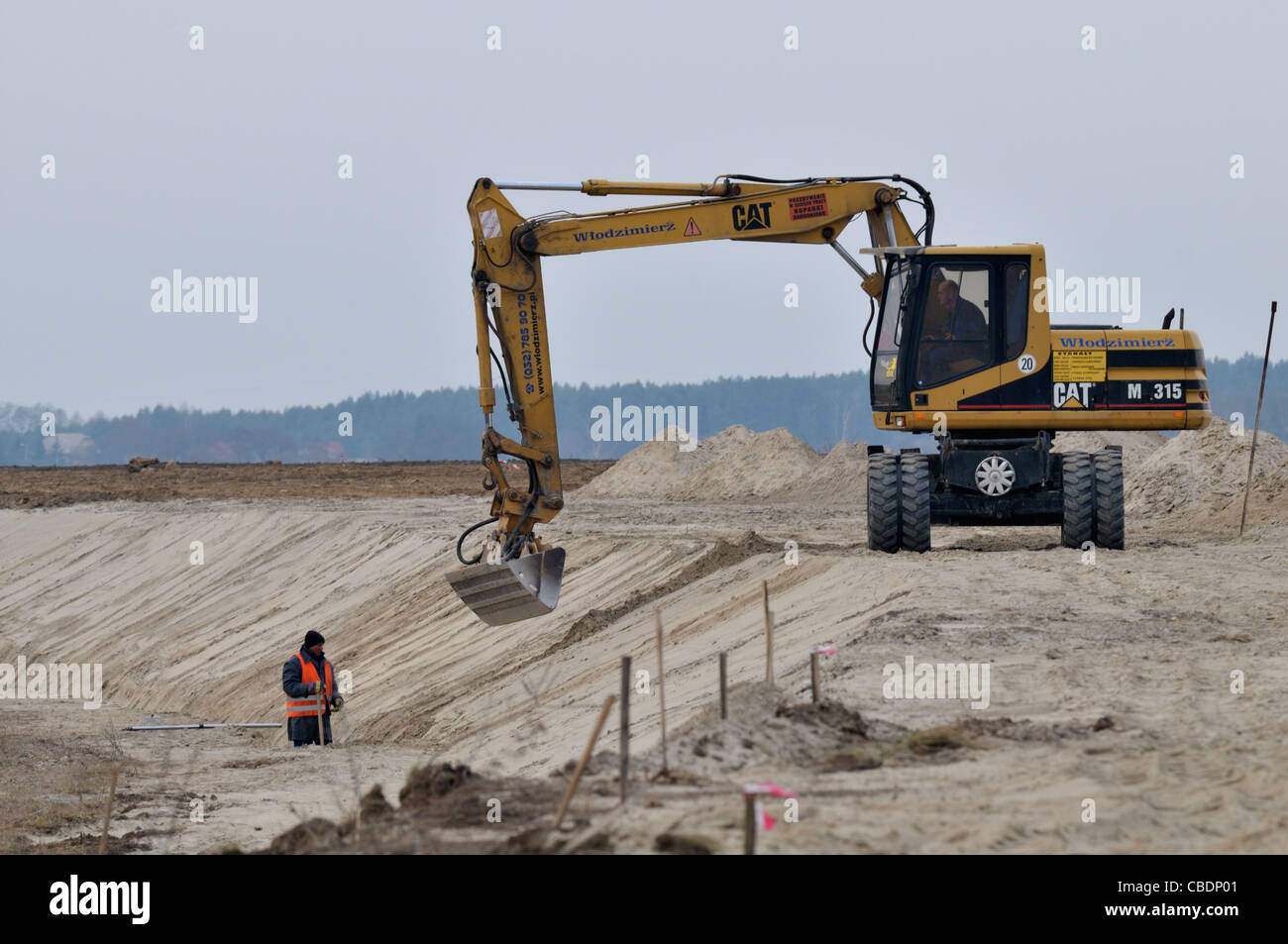 People and earth moving equipment at work Stock Photo - Alamy