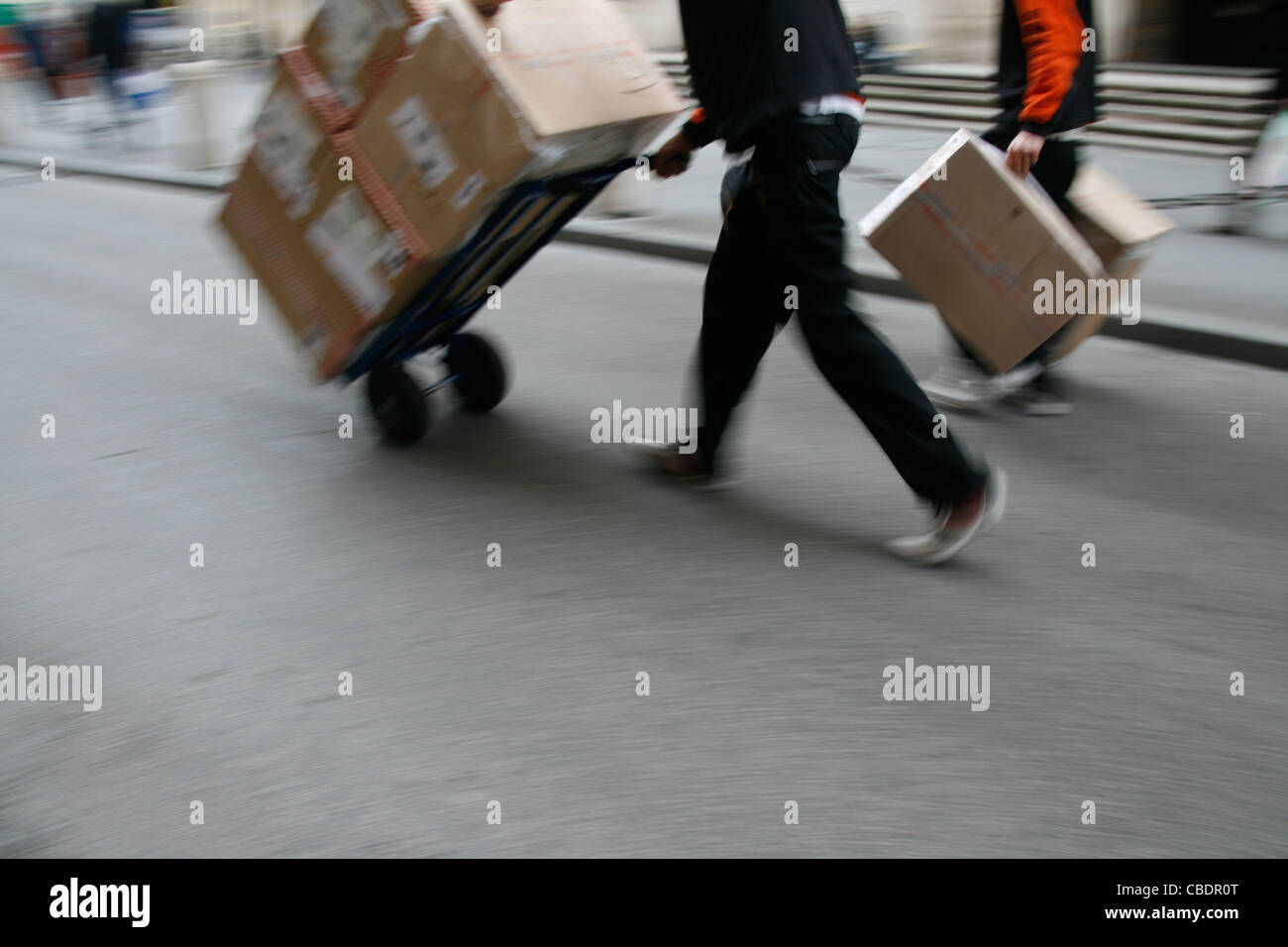 courier delivery walking in street road in city town Stock Photo - Alamy
