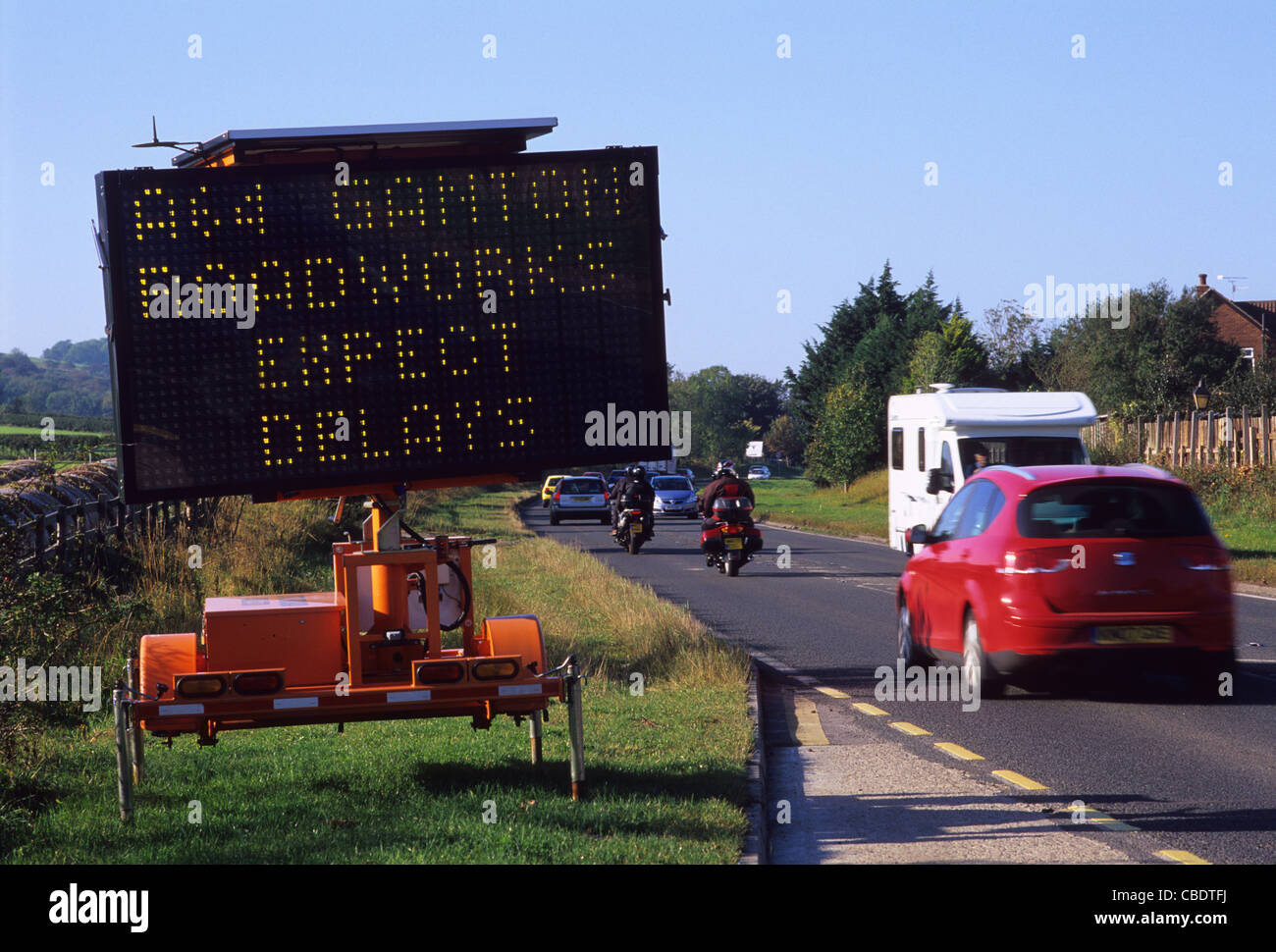 roadside electronic warning sign of roadworks and delays on road ahead ...