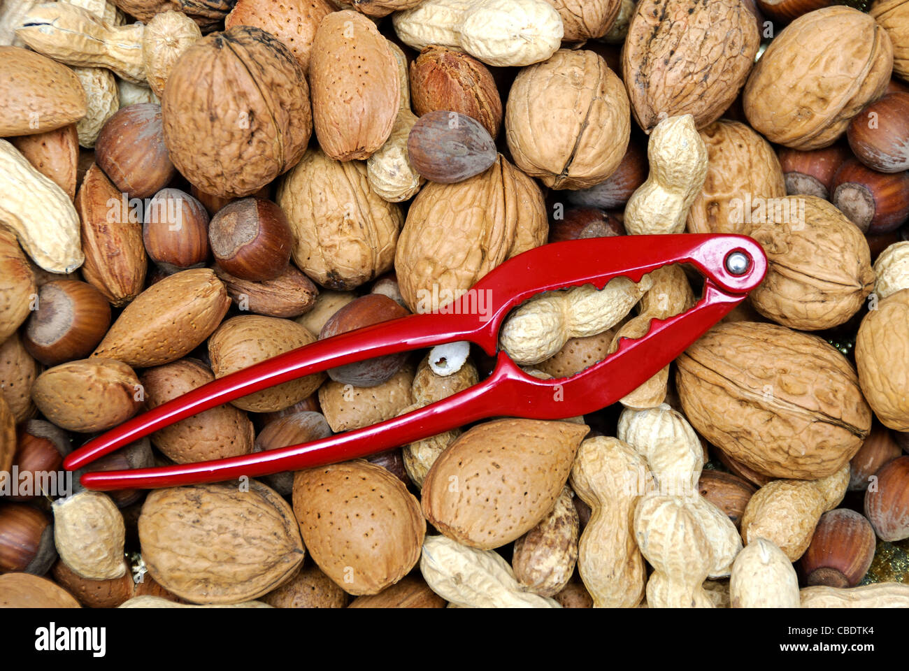 Red Nutcracker with nuts and peanuts Stock Photo - Alamy