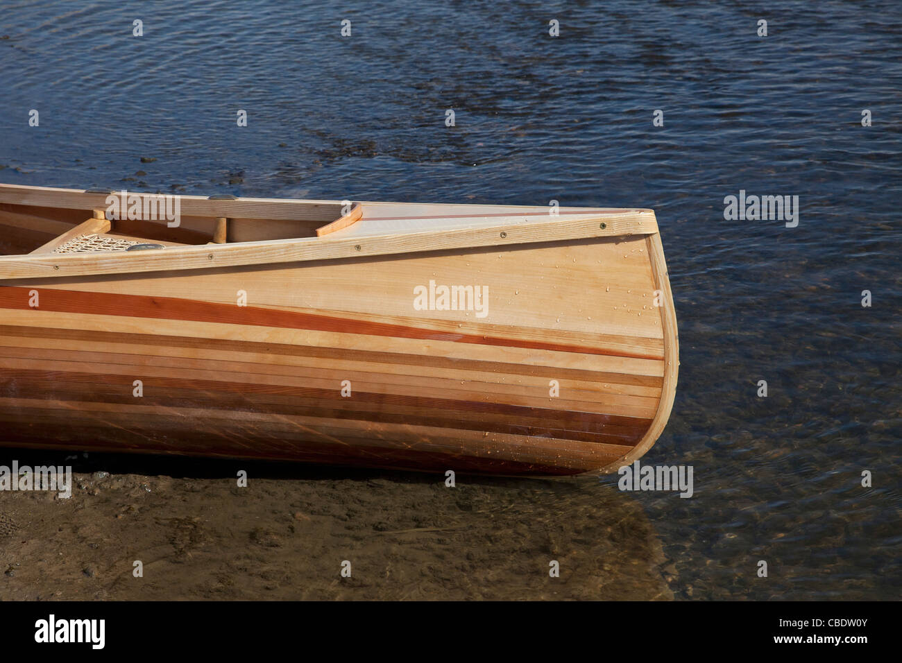 bow of beautiful classic wooden canoe home build from stripes of ...