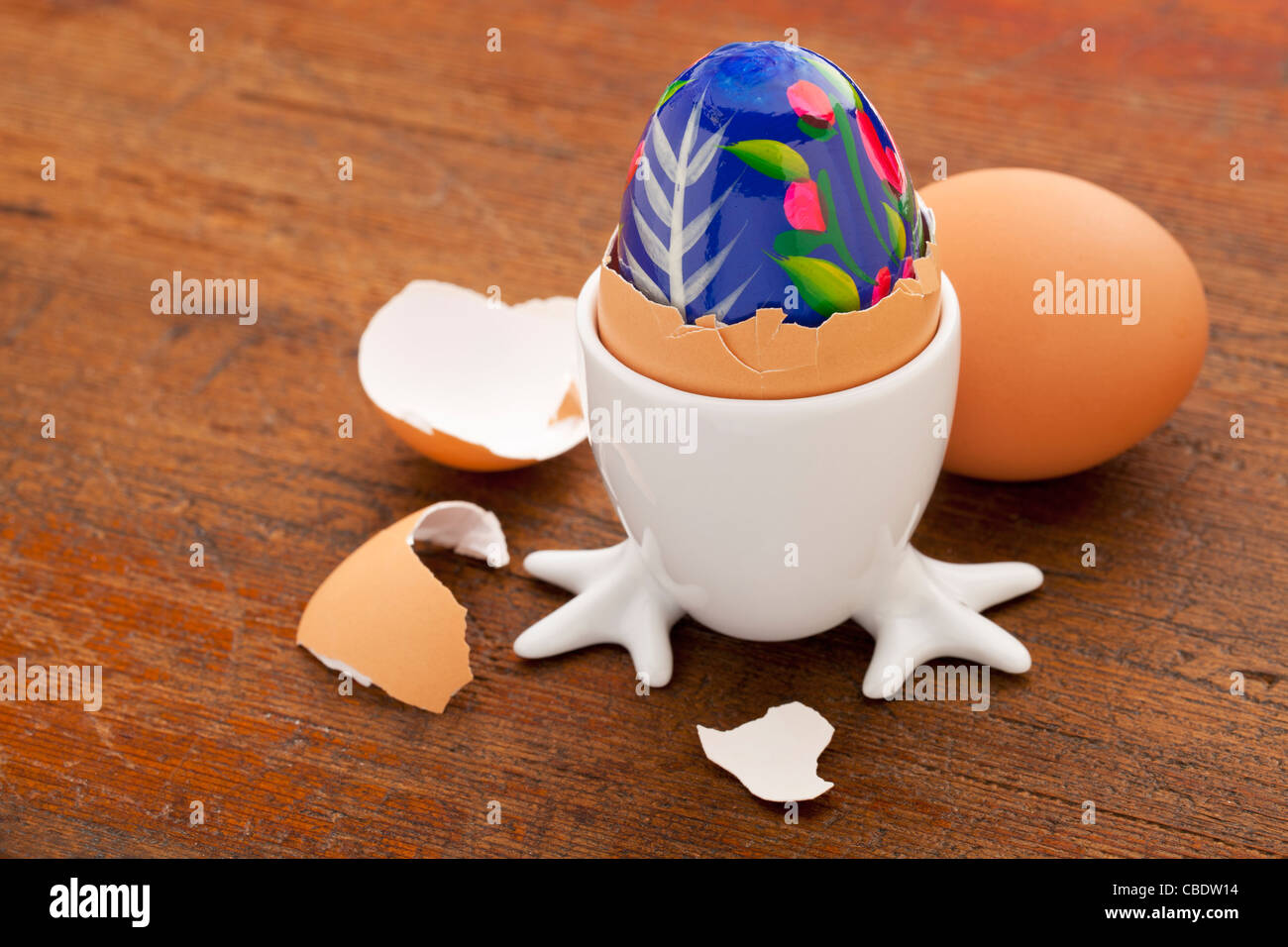 Easter decoration concept - painted egg hatching from a regular chicken ...