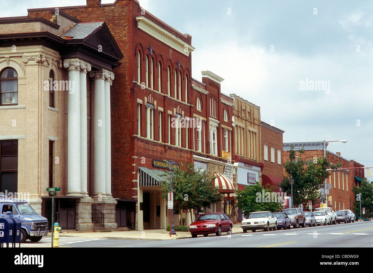 An old-fashioned downtown of red brick stores and trees, in Statesville ...