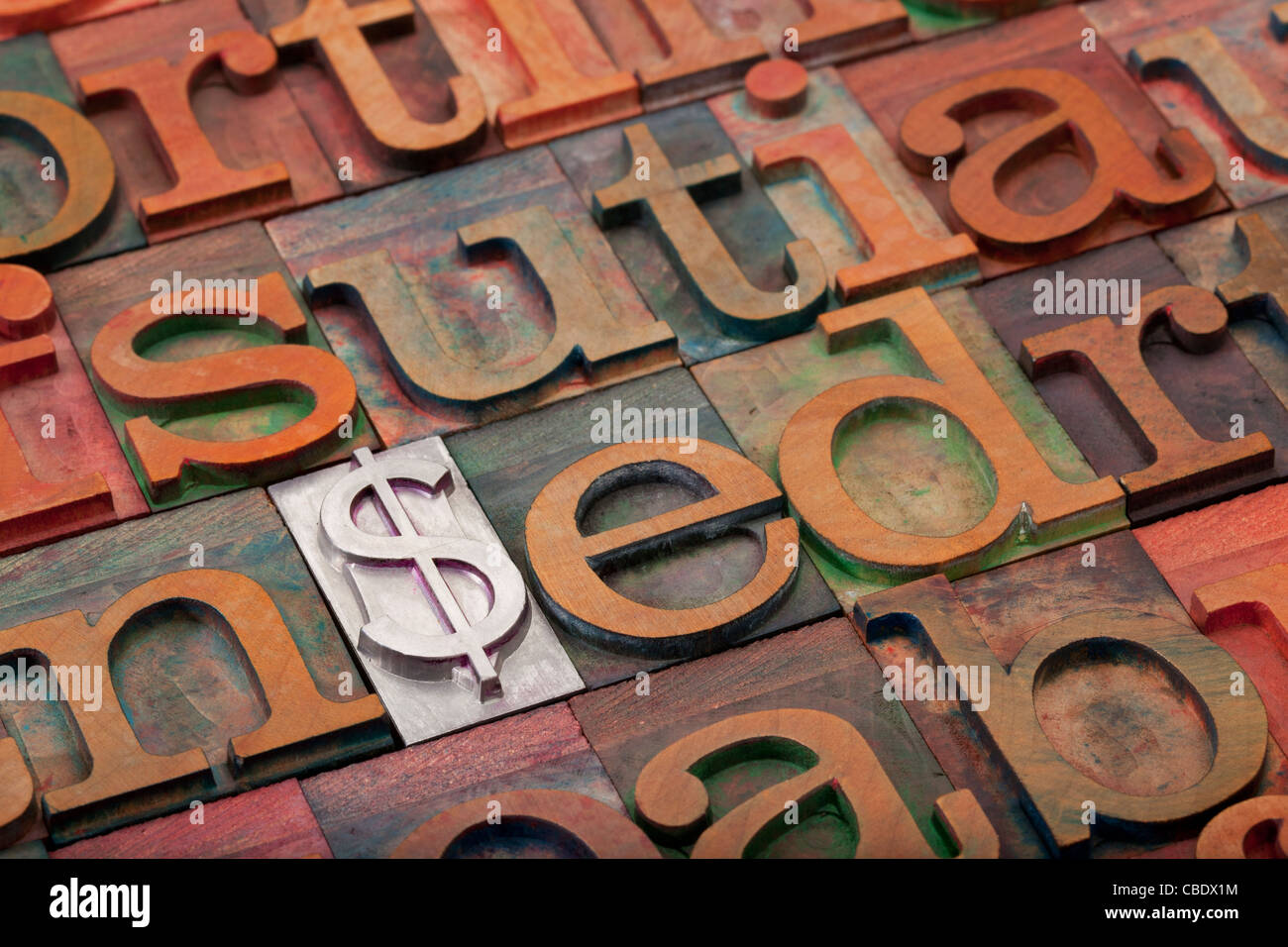metal dollar sign among vintage wooden letterpress printing blocks ...