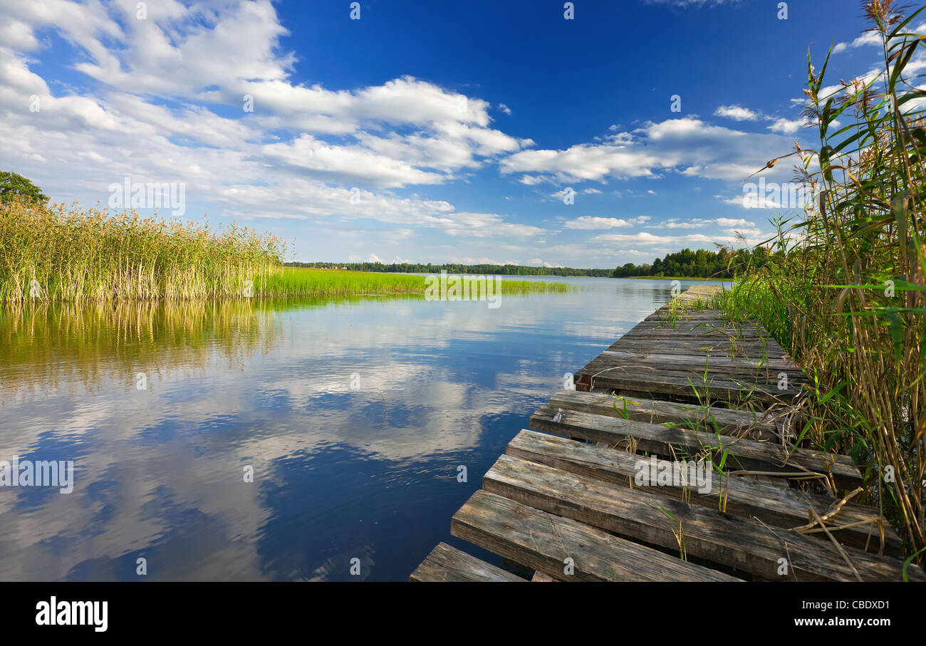 Summer's lake scenery with wooden bridge Stock Photo - Alamy