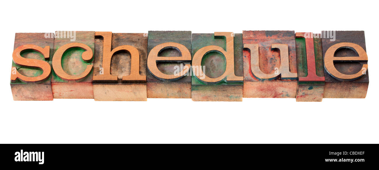 schedule word in vintage wooden letterpress printing blocks, stained by ...