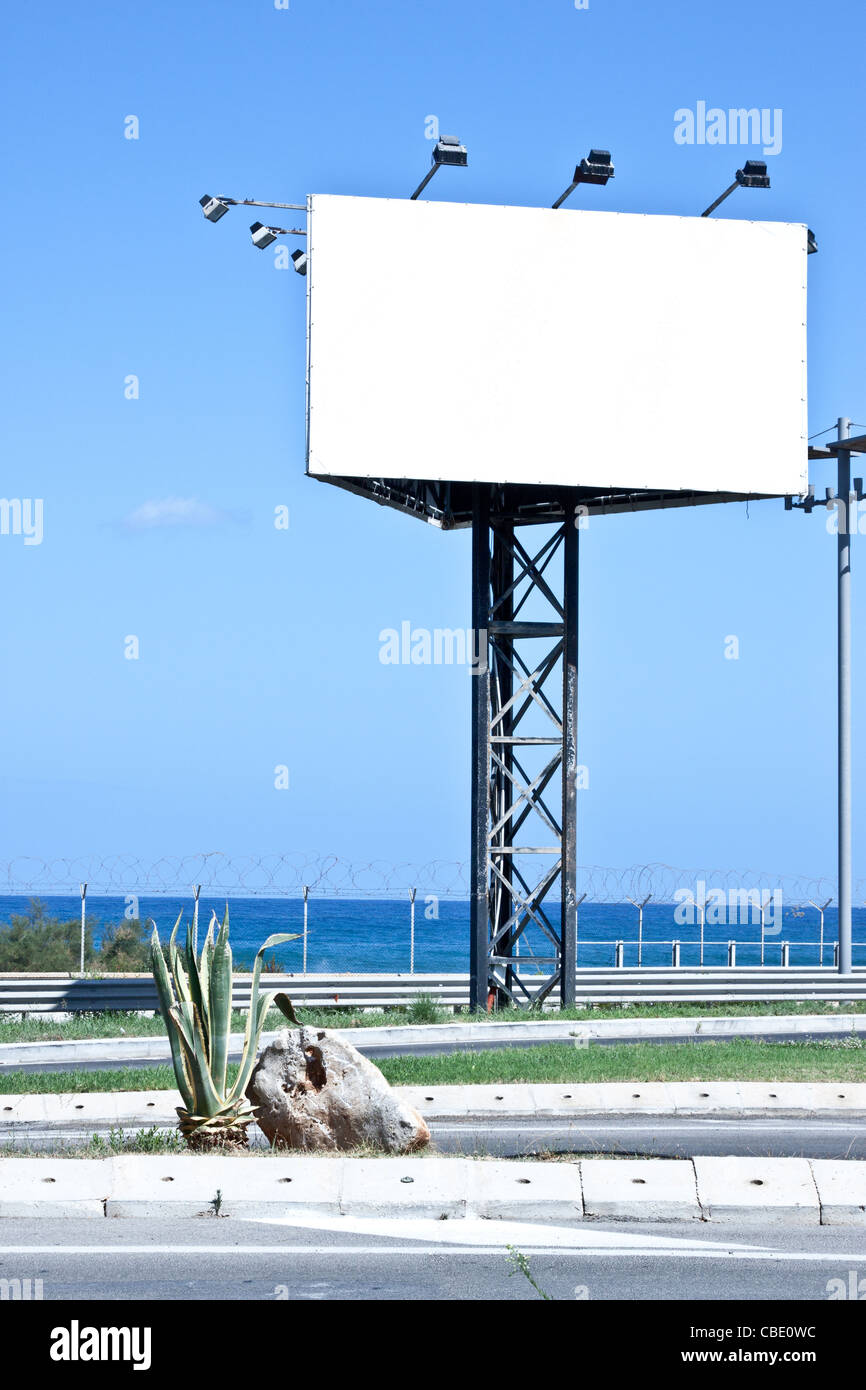 A White Poster advertising in blue sky Stock Photo - Alamy