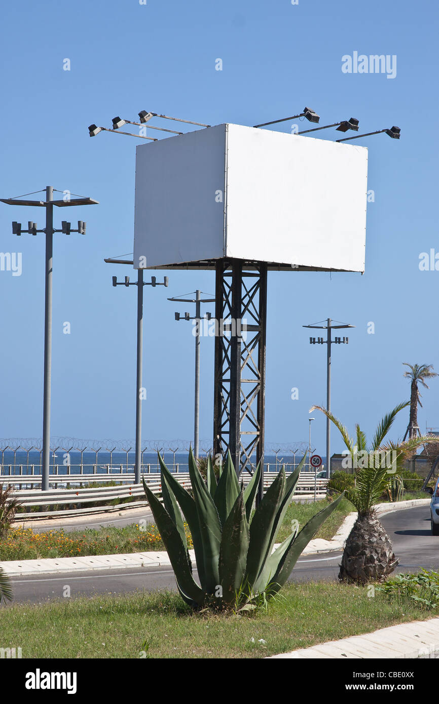 A White Poster advertising in blue sky Stock Photo - Alamy