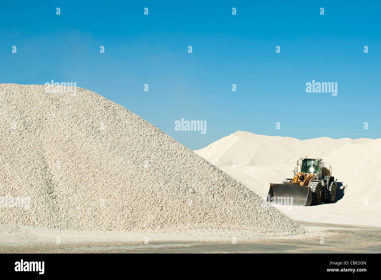Excavator in a limestone quarry.Piles of limestone rocks Stock Photo ...