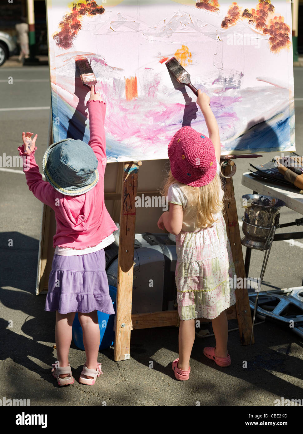 Two little girls painting Stock Photo - Alamy